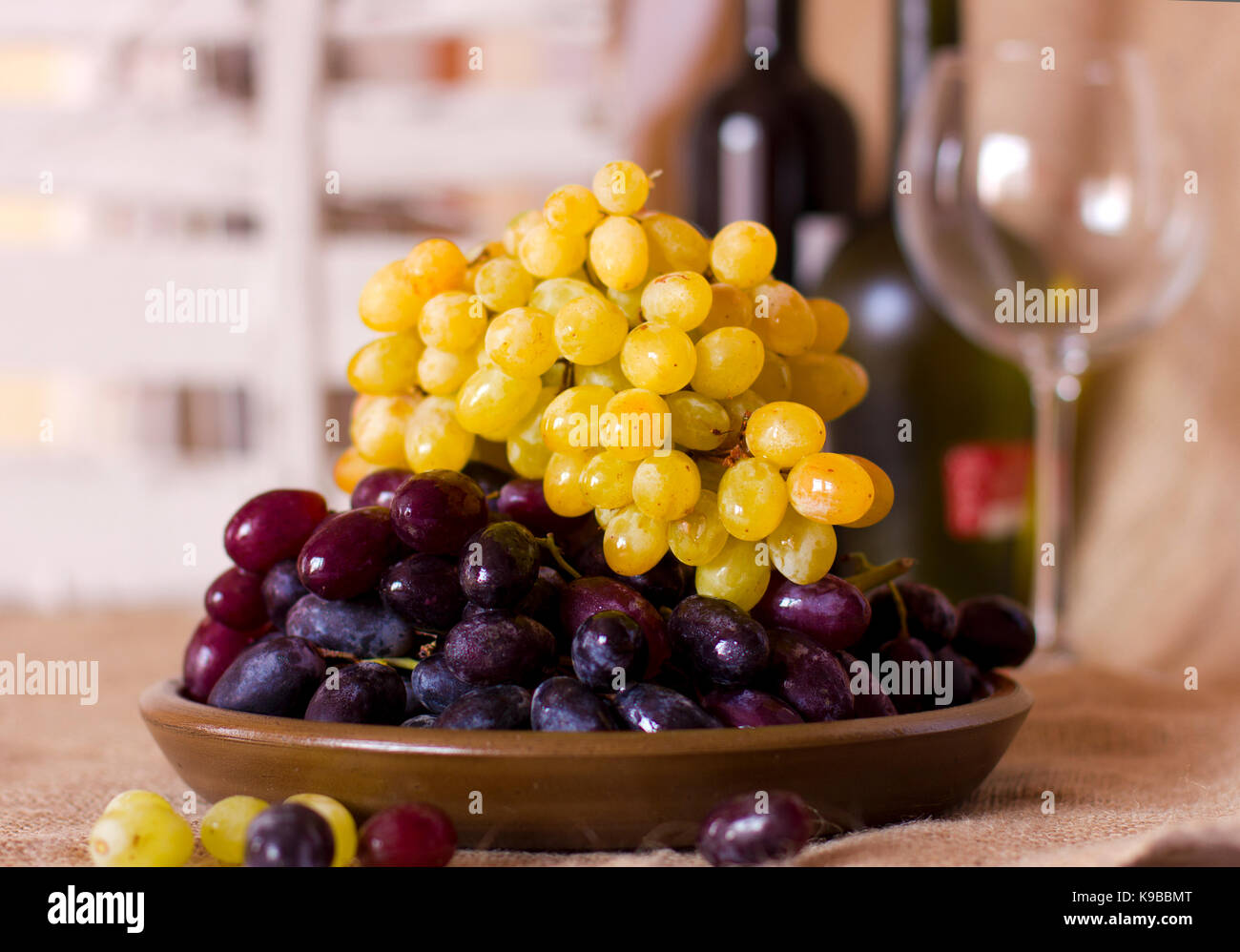 Blue and green grapes on the clay brown dish Stock Photo - Alamy