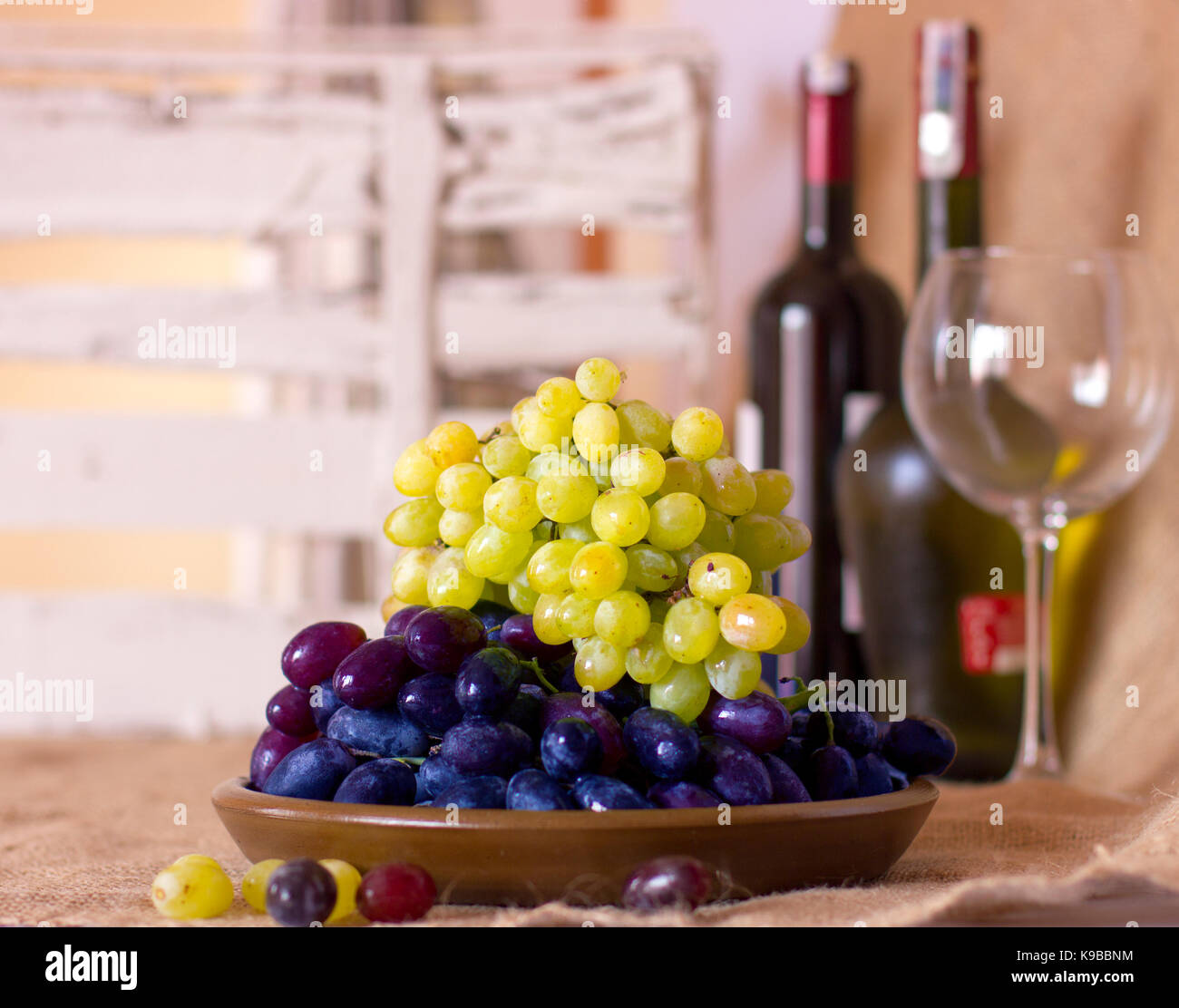 Blue and green grapes on the clay brown dish Stock Photo - Alamy
