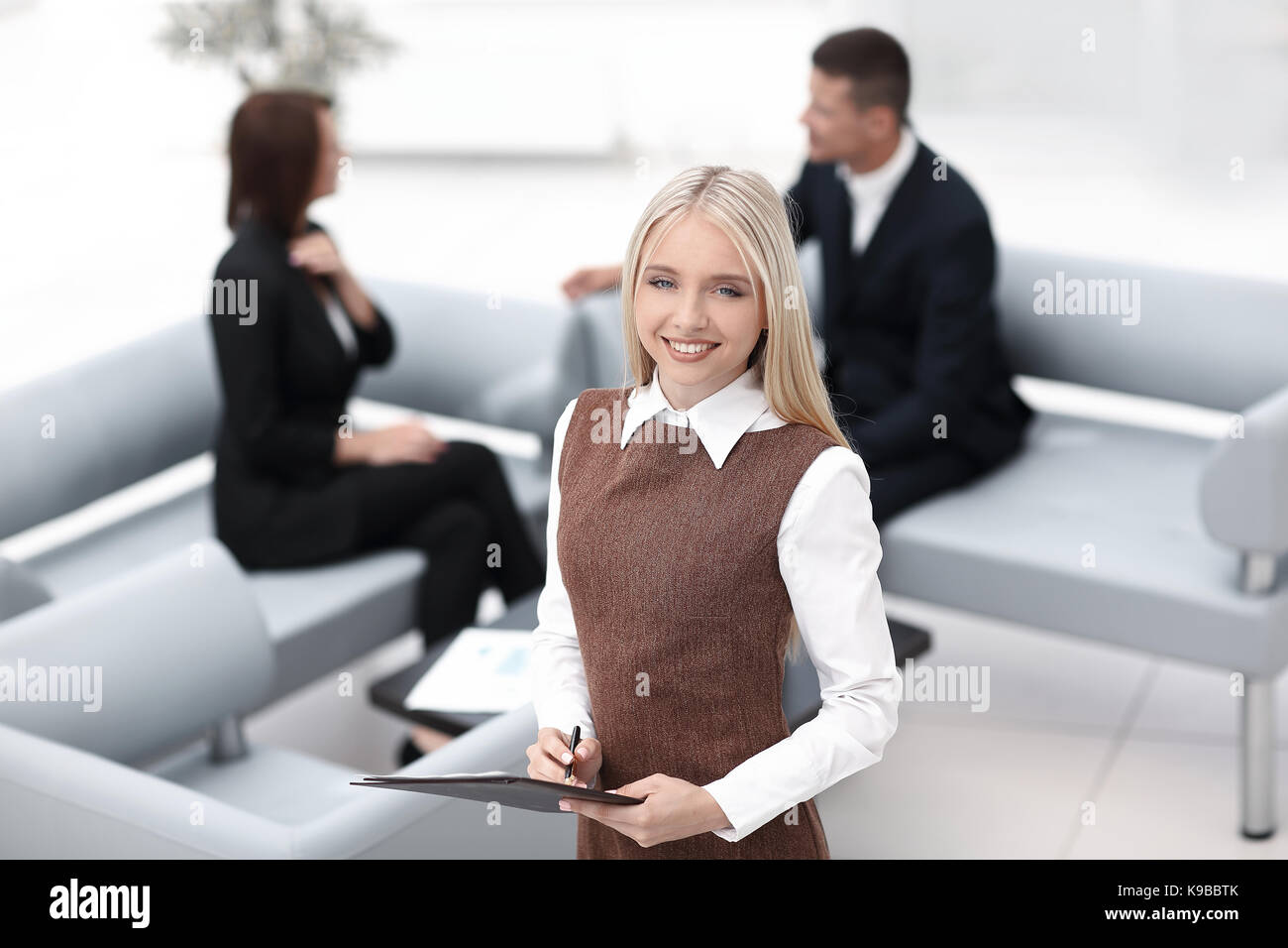 young woman assistant standing in the lobby of the modern office Stock ...