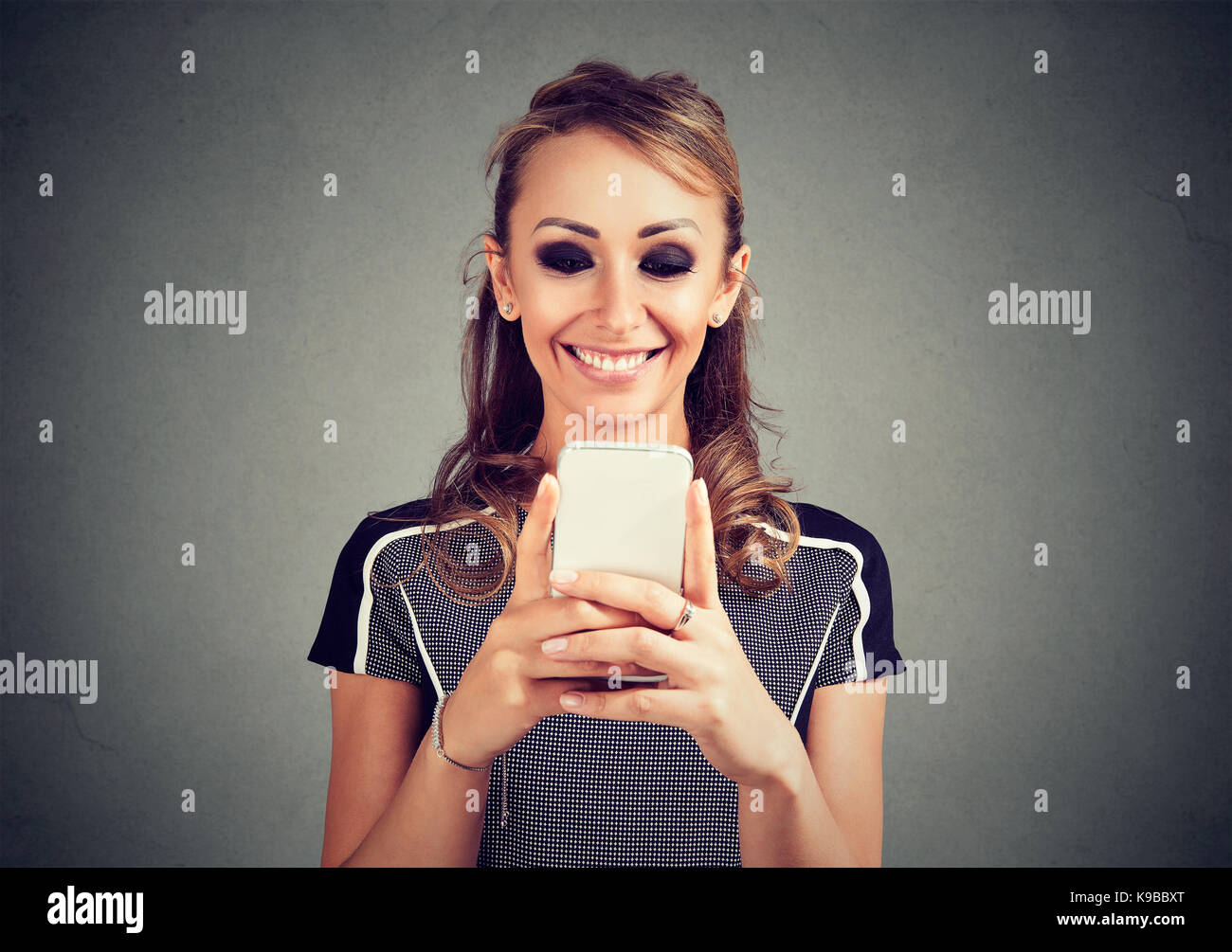 Young smiling woman using a mobile phone Stock Photo - Alamy
