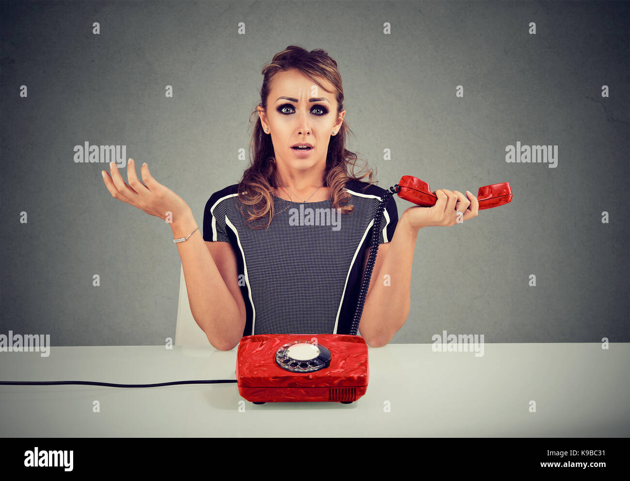 Shocked woman receiving bad news on the phone Stock Photo - Alamy