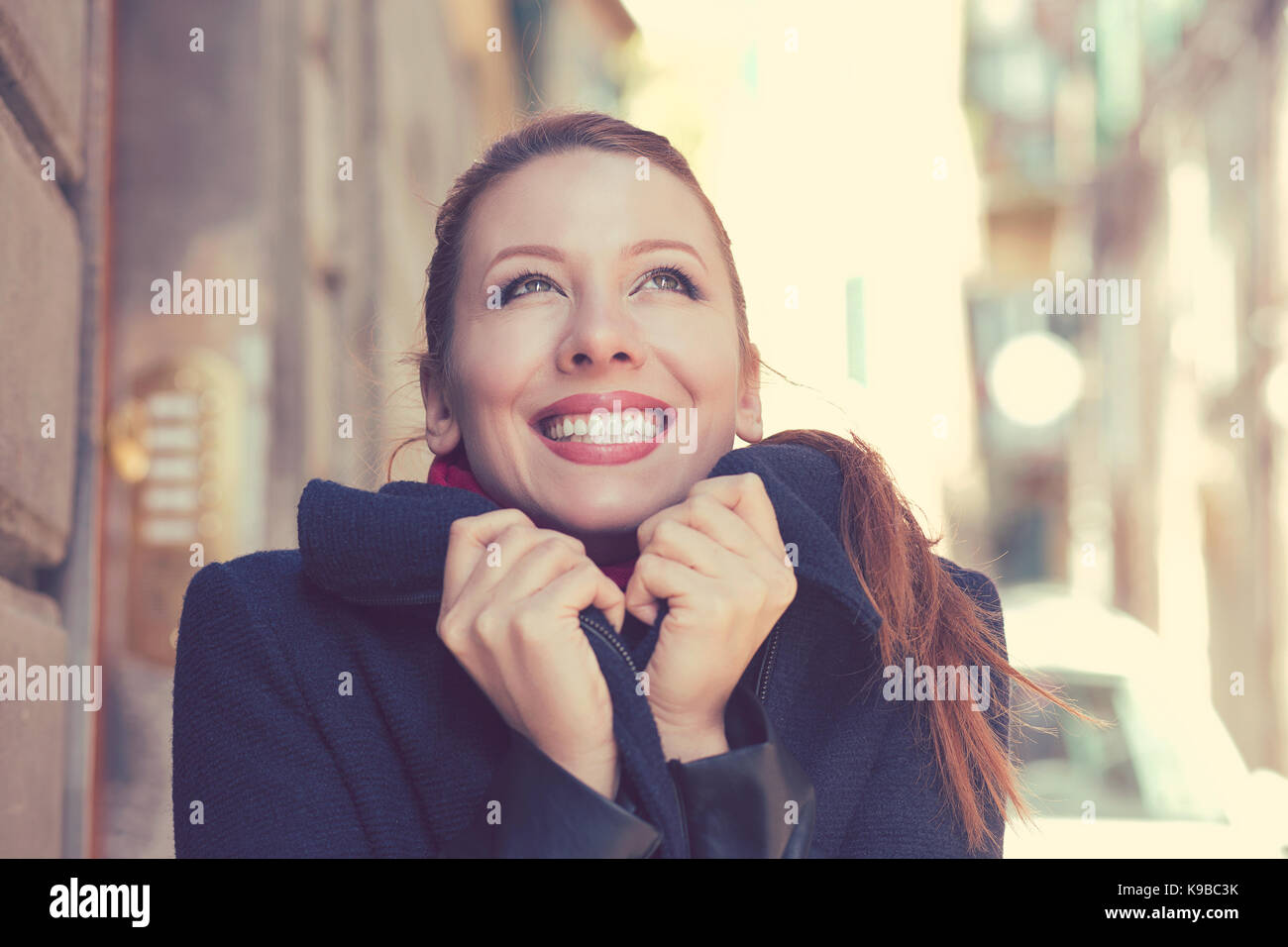 Beautiful young woman with perfect white smile feeling happy and warm ...