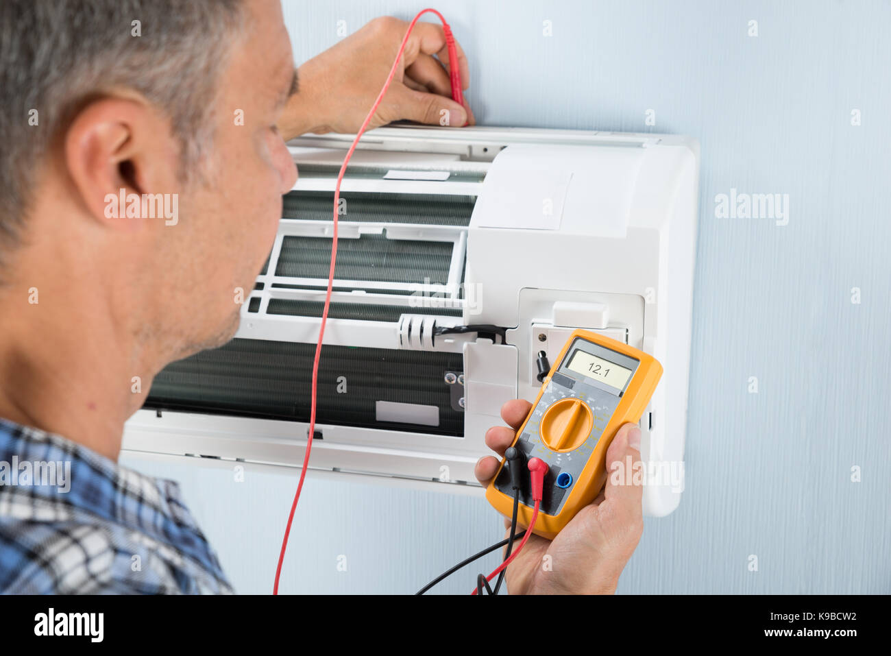 Portrait Of A Mid-adult Male Technician Testing Air Conditioner With ...