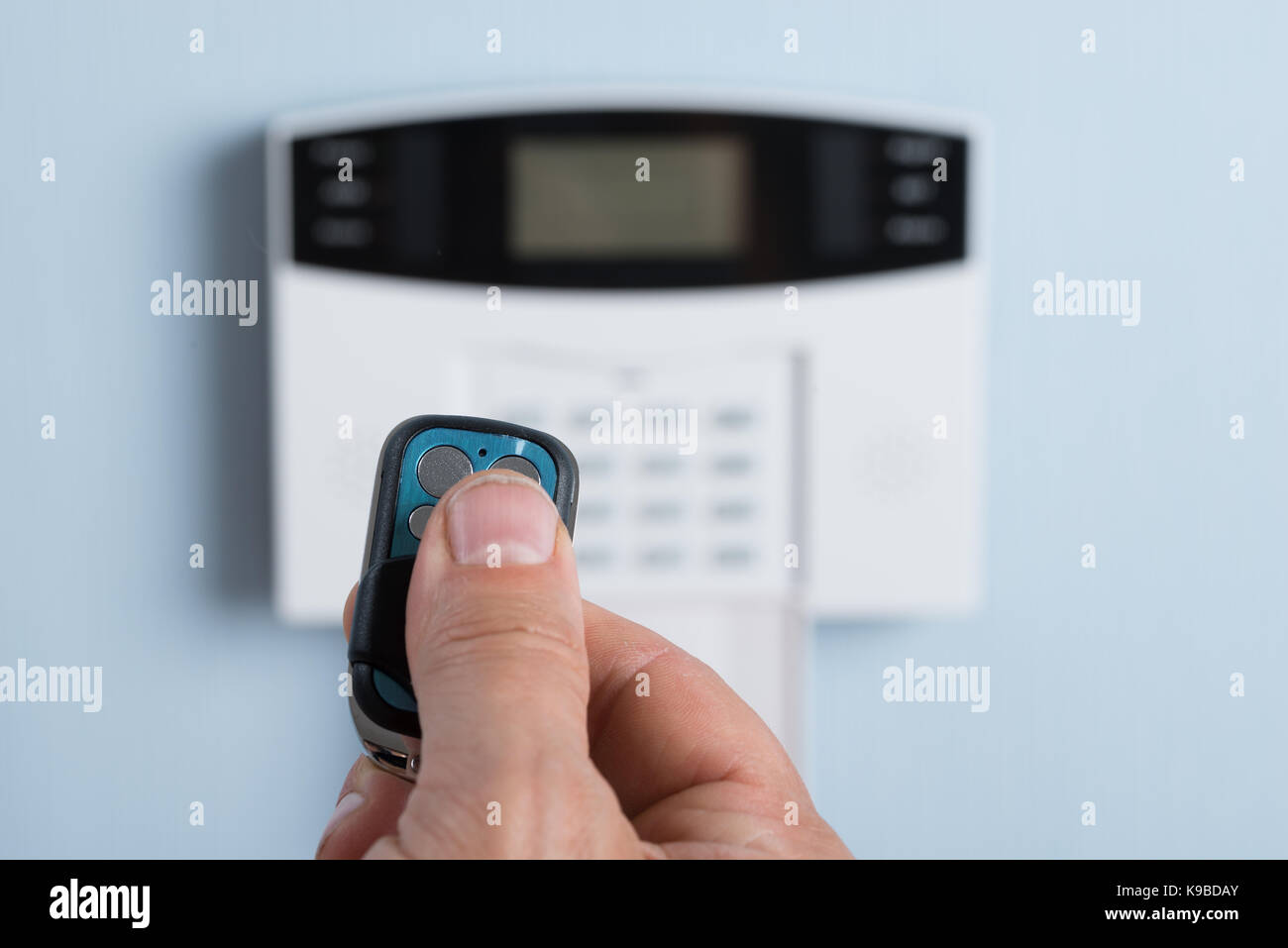 Close-up Of A Person's Hand Using Remote Control To Disarm The Security ...