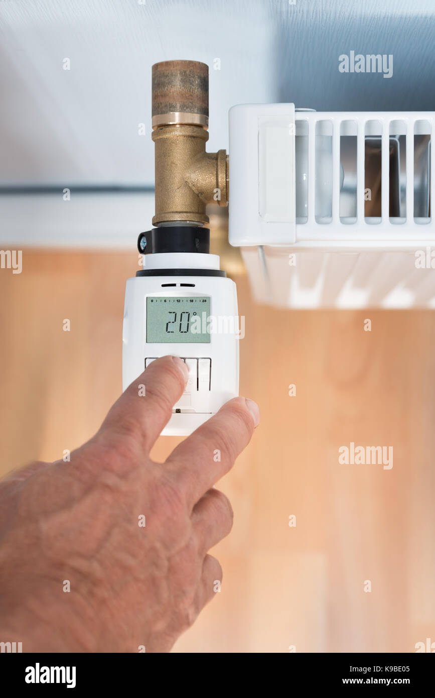 Close-up Of A Person's Hand Adjusting Temperature On Thermostat Stock ...