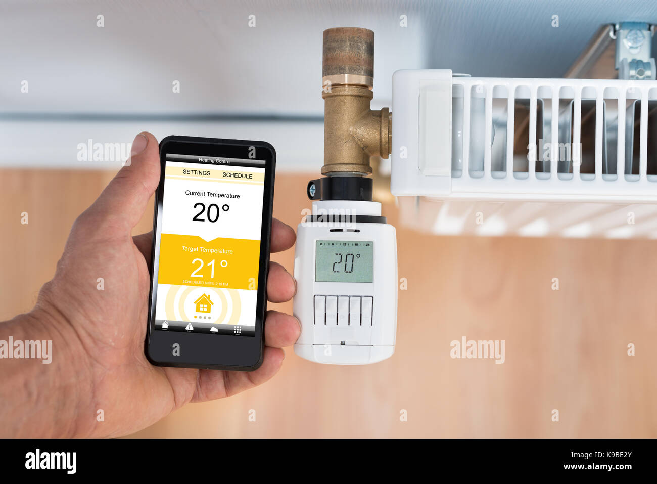 Close-up Of Person's Hand Adjusting Temperature Of Thermostat Using ...
