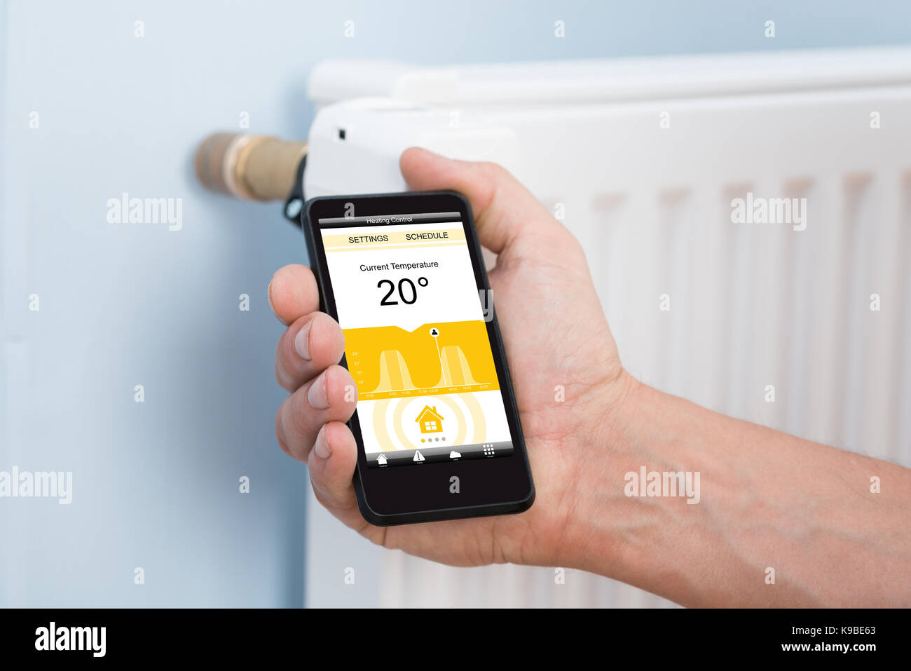 Close-up Of Person's Hand Adjusting Temperature Of Thermostat Using ...