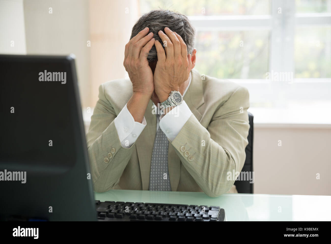 Photo Of Depressed Businessman Sitting In Office Stock Photo - Alamy