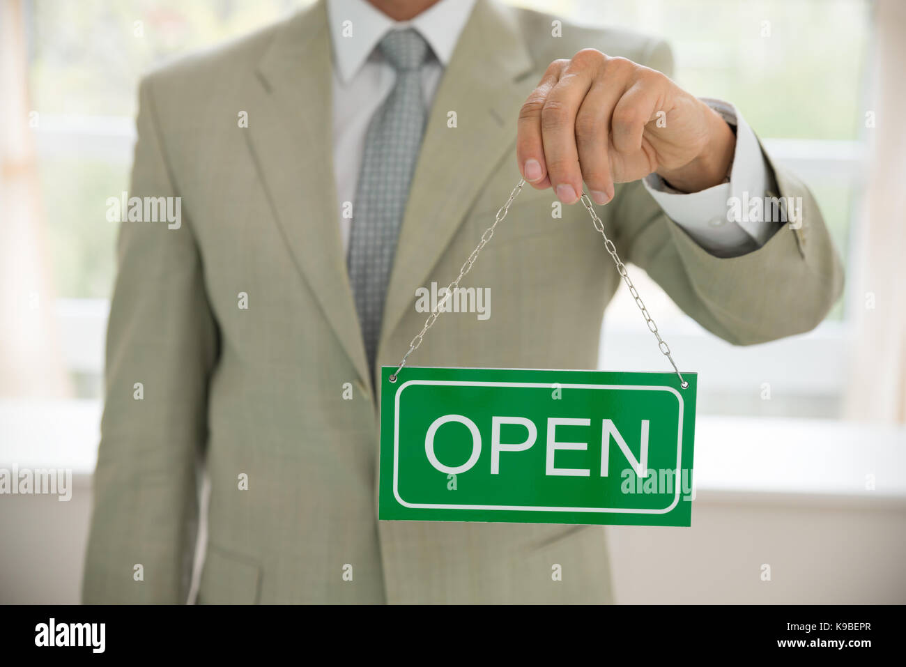 Close-up Of A Businessman Holding Open Sign Stock Photo - Alamy