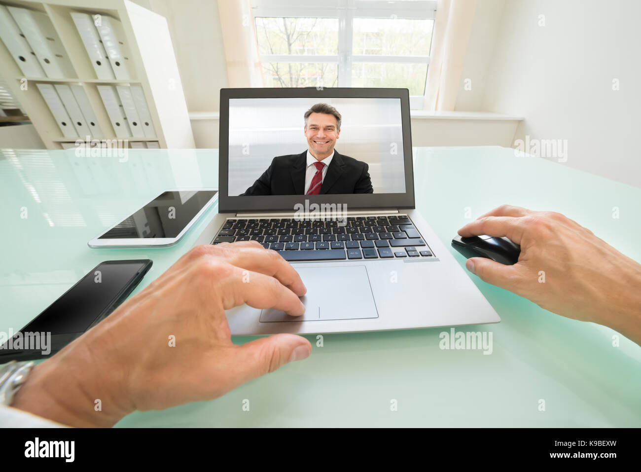 Close-up Of A Person Having Videochat With Businessman In Office ...