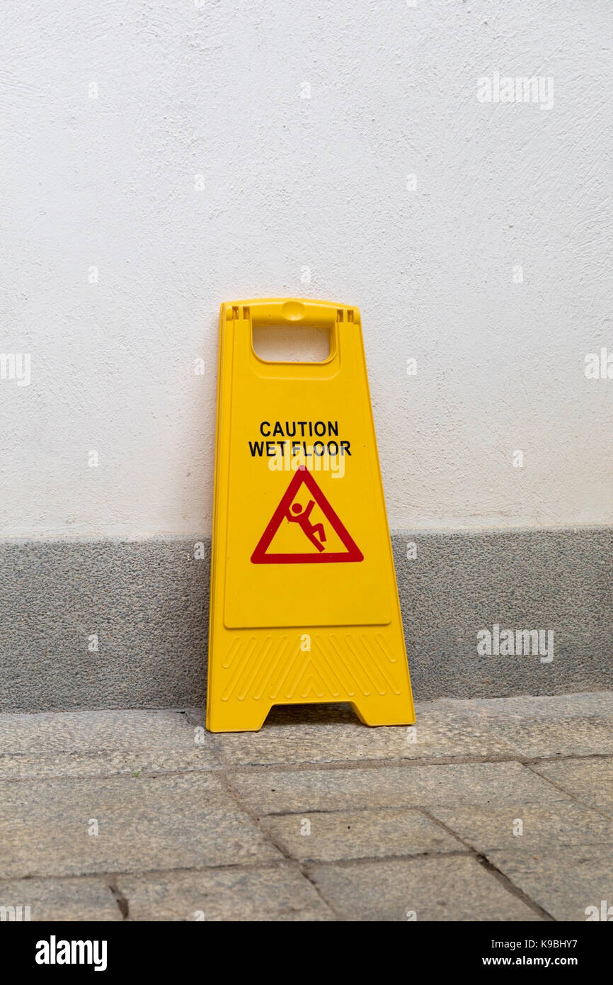 Yellow Warning Sign For Wet Floor Stock Photo - Alamy