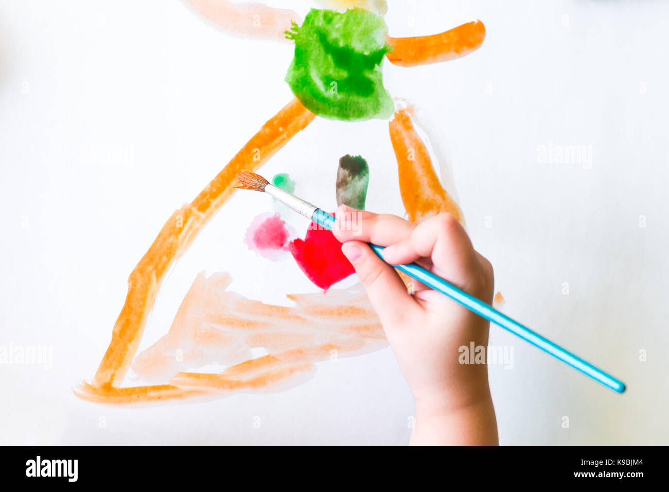 Kid is drawing with watercolors Stock Photo - Alamy