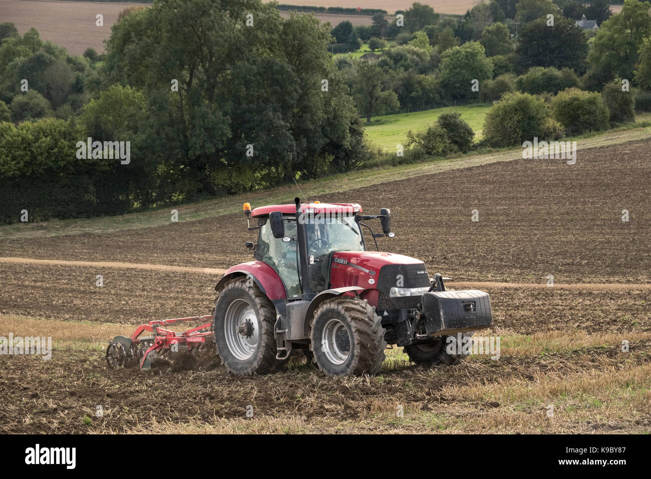 Stapleton, Herefordshire, UK. Harrowing fields after harvest, early ...