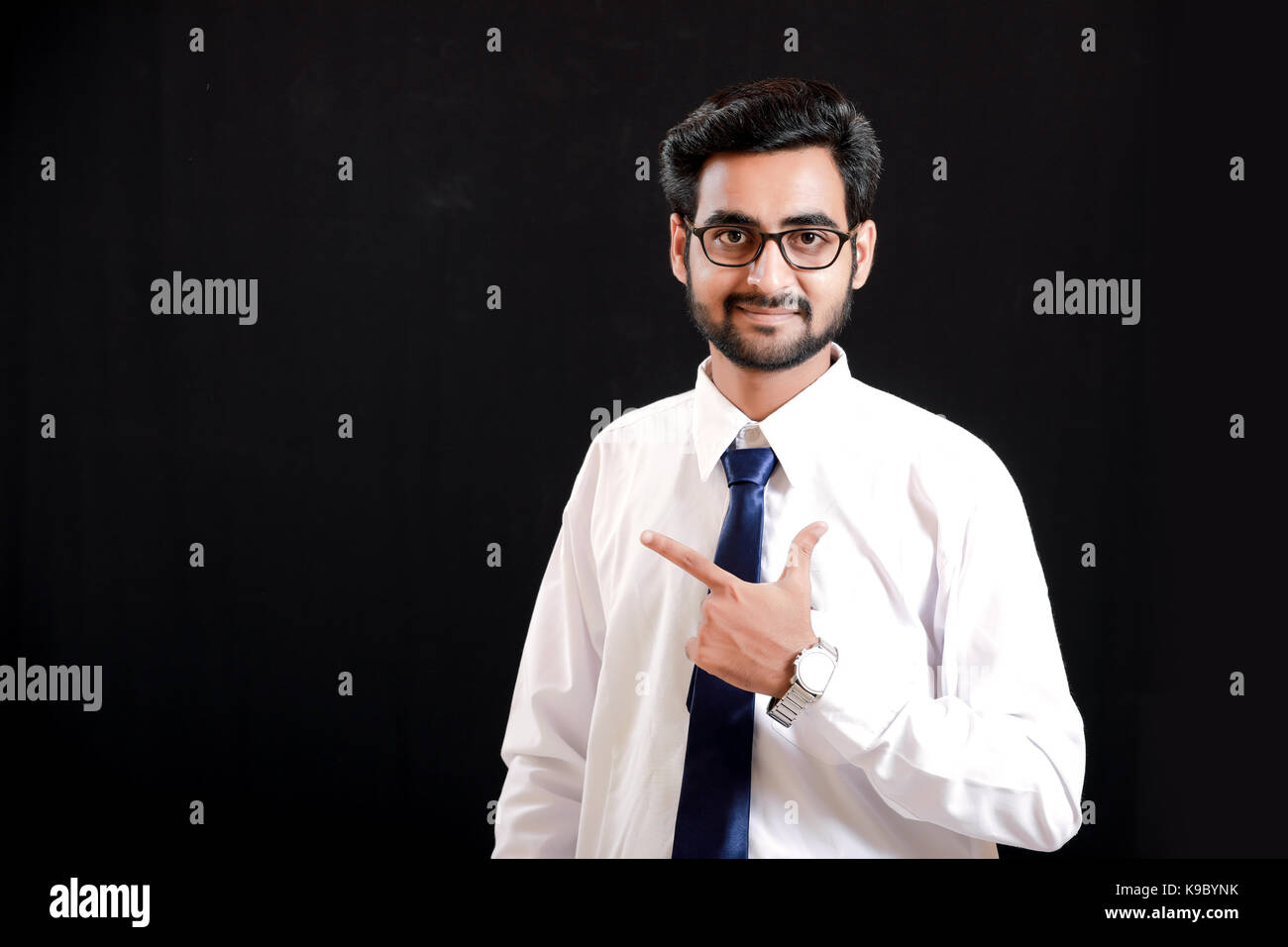 Indian young man showing direction with hand Stock Photo - Alamy
