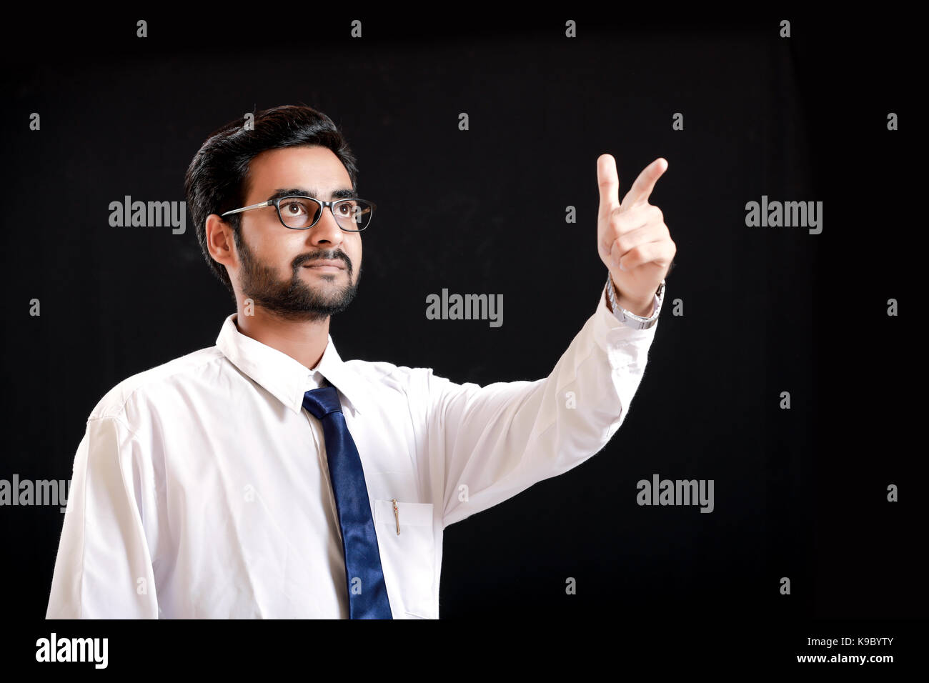 Indian young man showing direction with hand Stock Photo - Alamy