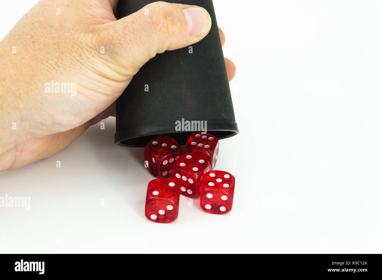 five red dices with hand and dice cup isolated Stock Photo - Alamy