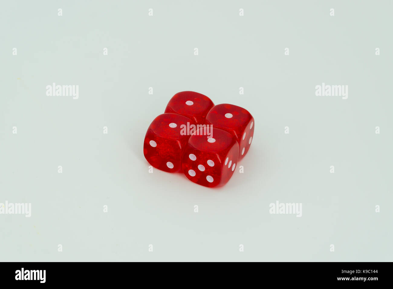 four red dices isolated Stock Photo - Alamy