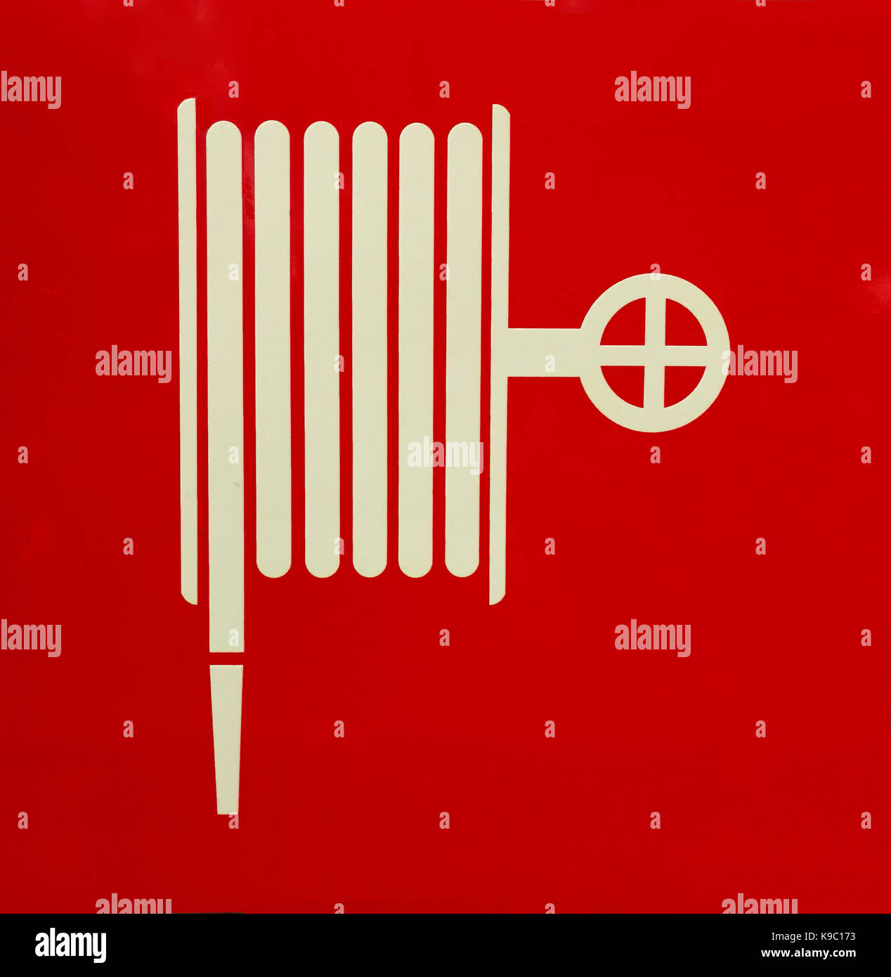 fire hose signal on red background Stock Photo - Alamy