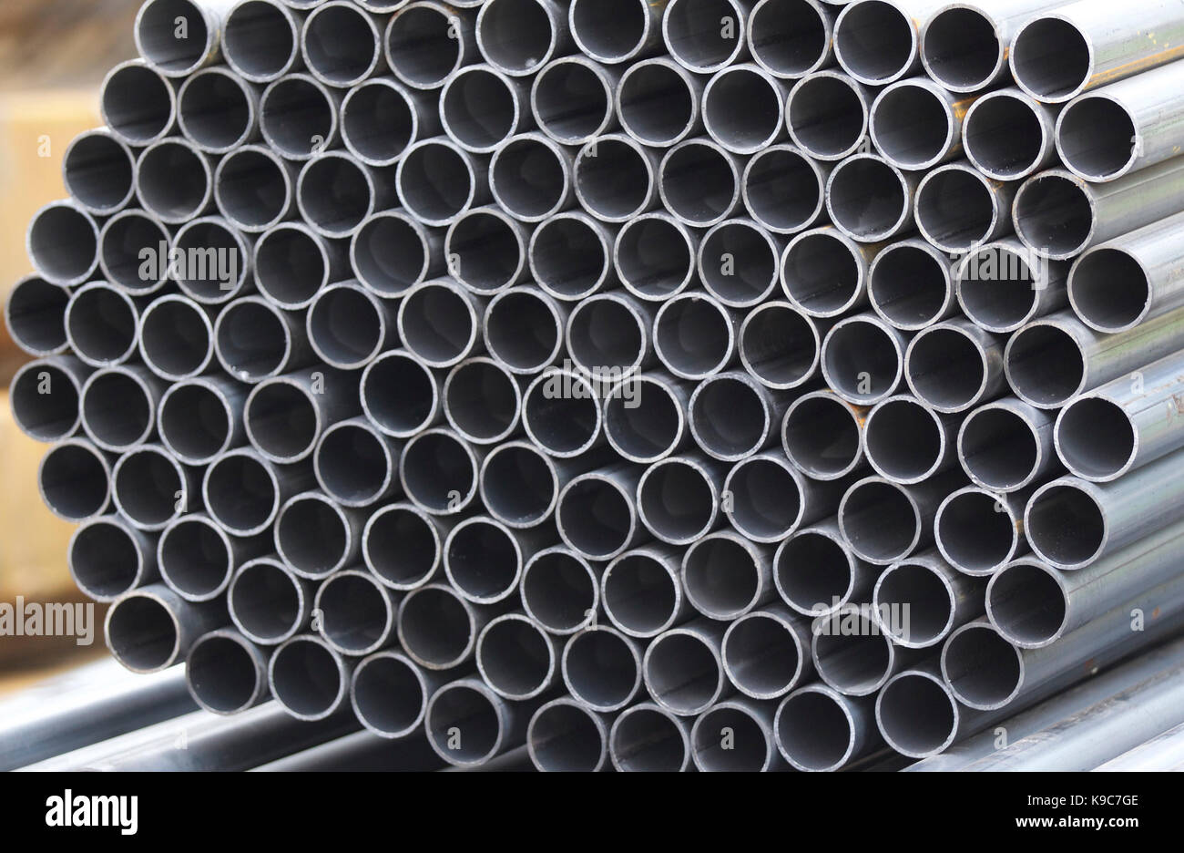 Metal profile pipe of round section in packs at the warehouse of metal ...