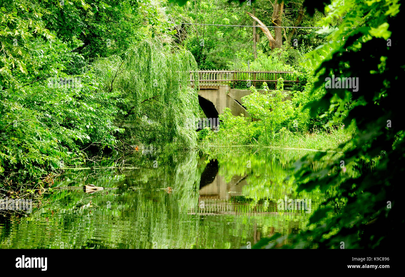Cracked bridge over channel leading to island Stock Photo - Alamy