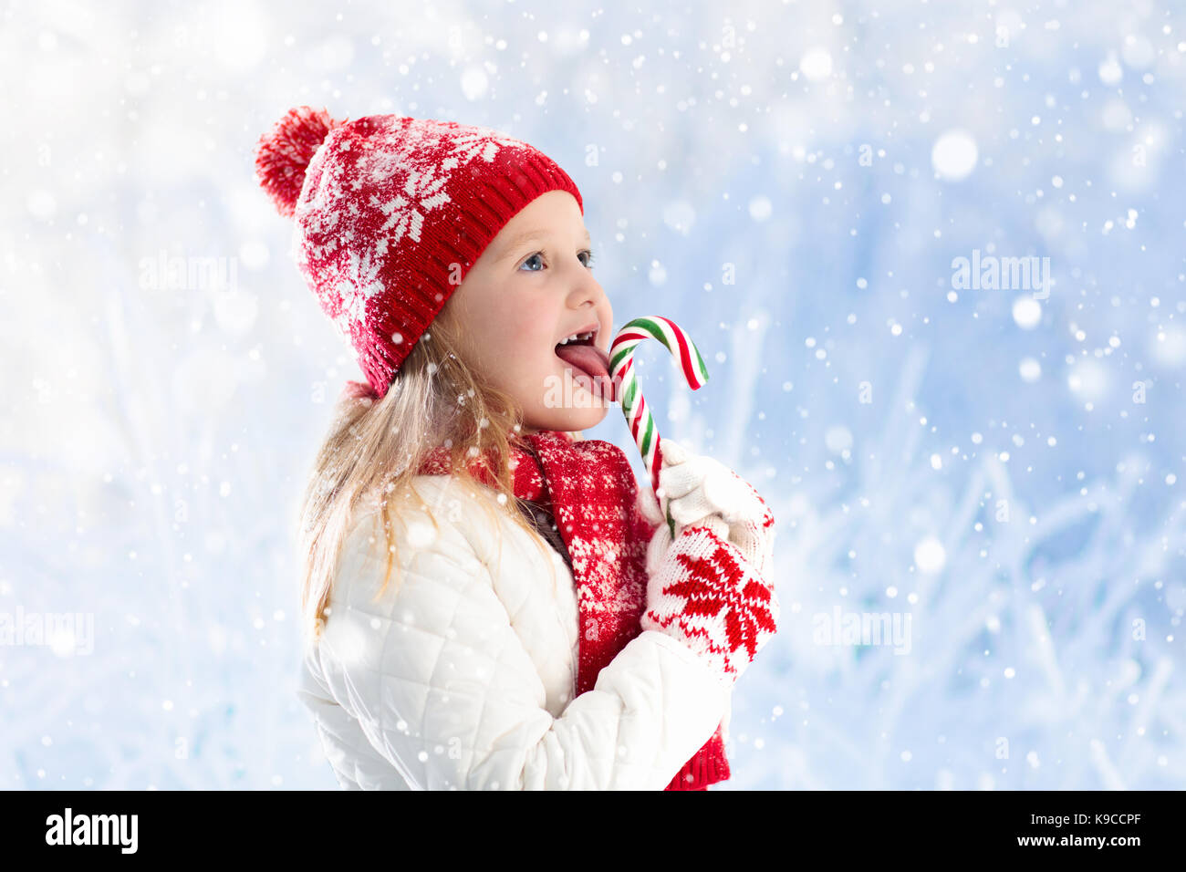 Child eating candy apple on winter fair. Kids eat toffee apples on ...