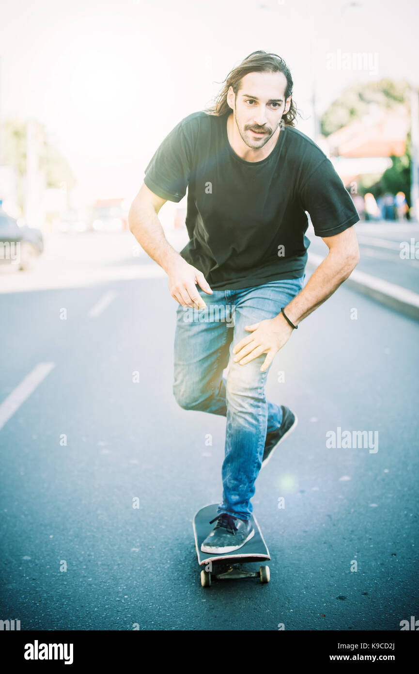 Pro skateboarder ride skateboard on the capital city road streets ...