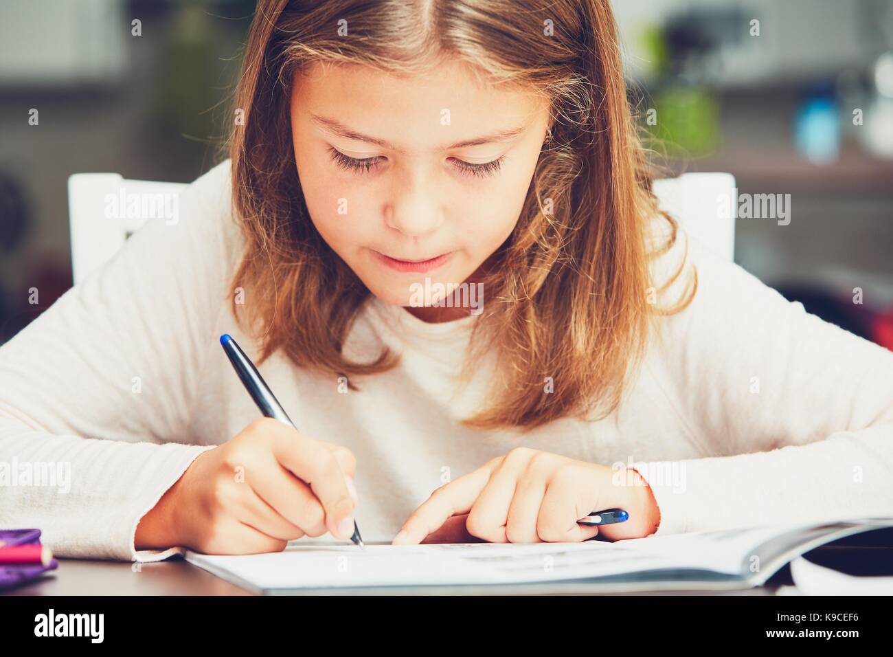 Little girl writing his homework for elementary school Stock Photo - Alamy