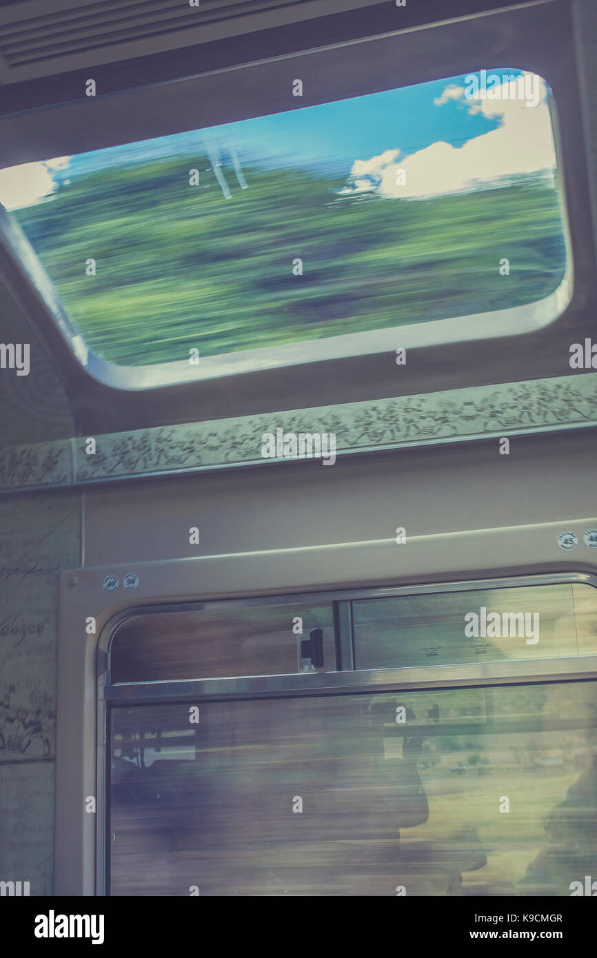 View through the windows of a moving train Stock Photo - Alamy