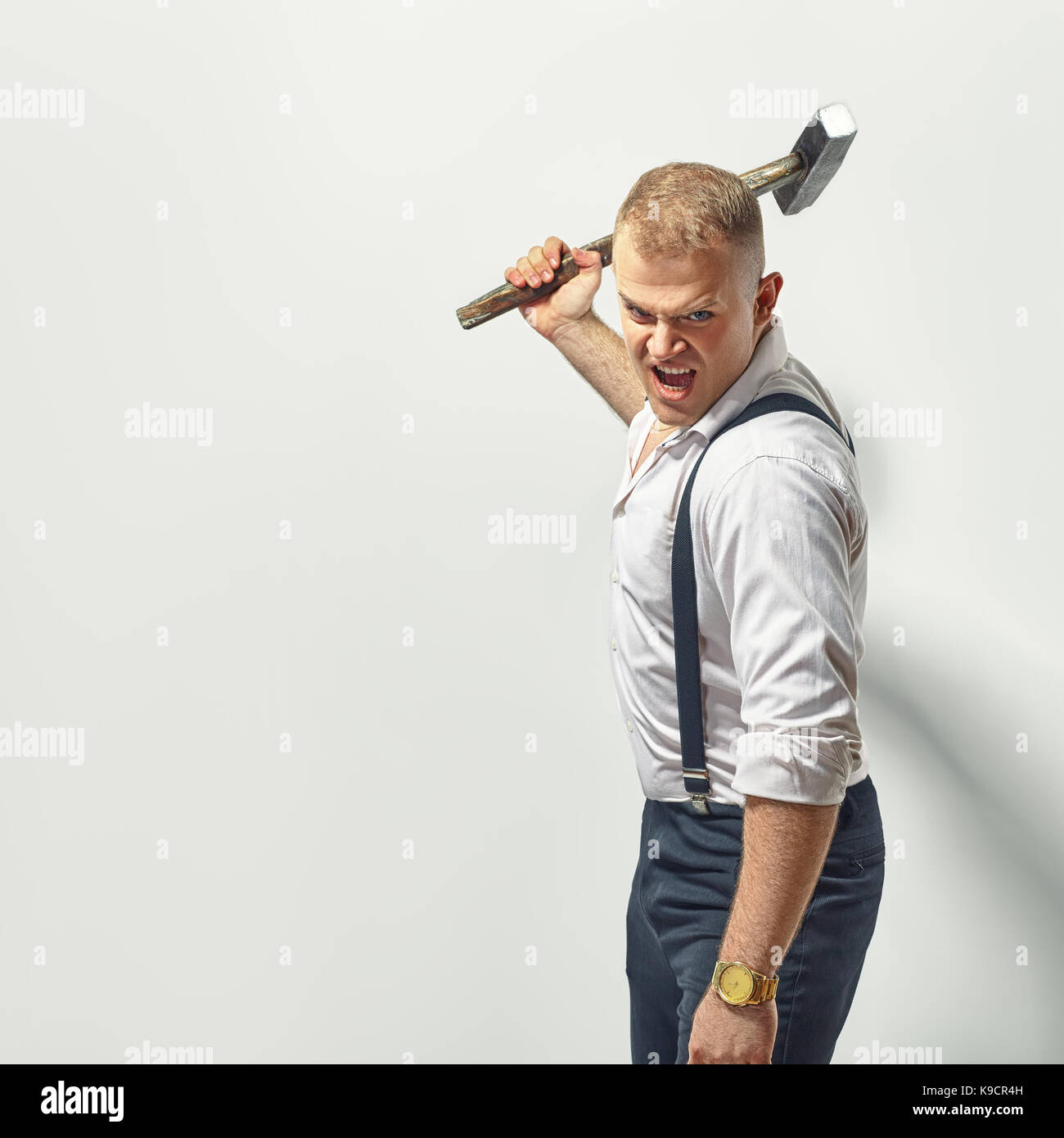 Angry man with hammer Stock Photo - Alamy