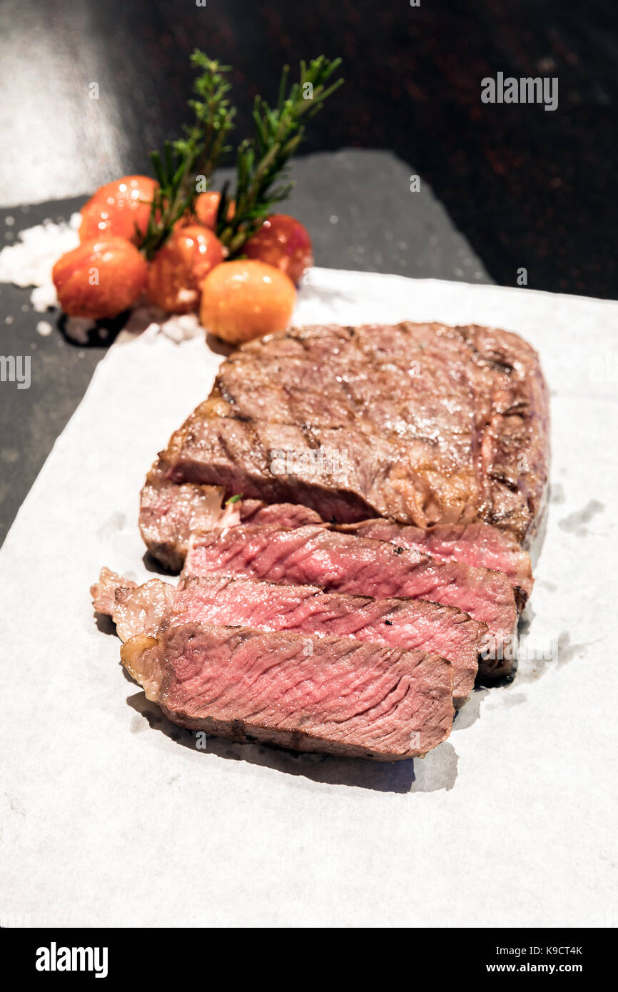 Prime tenderloin beef steak served with grilled tomato with sea salt ...