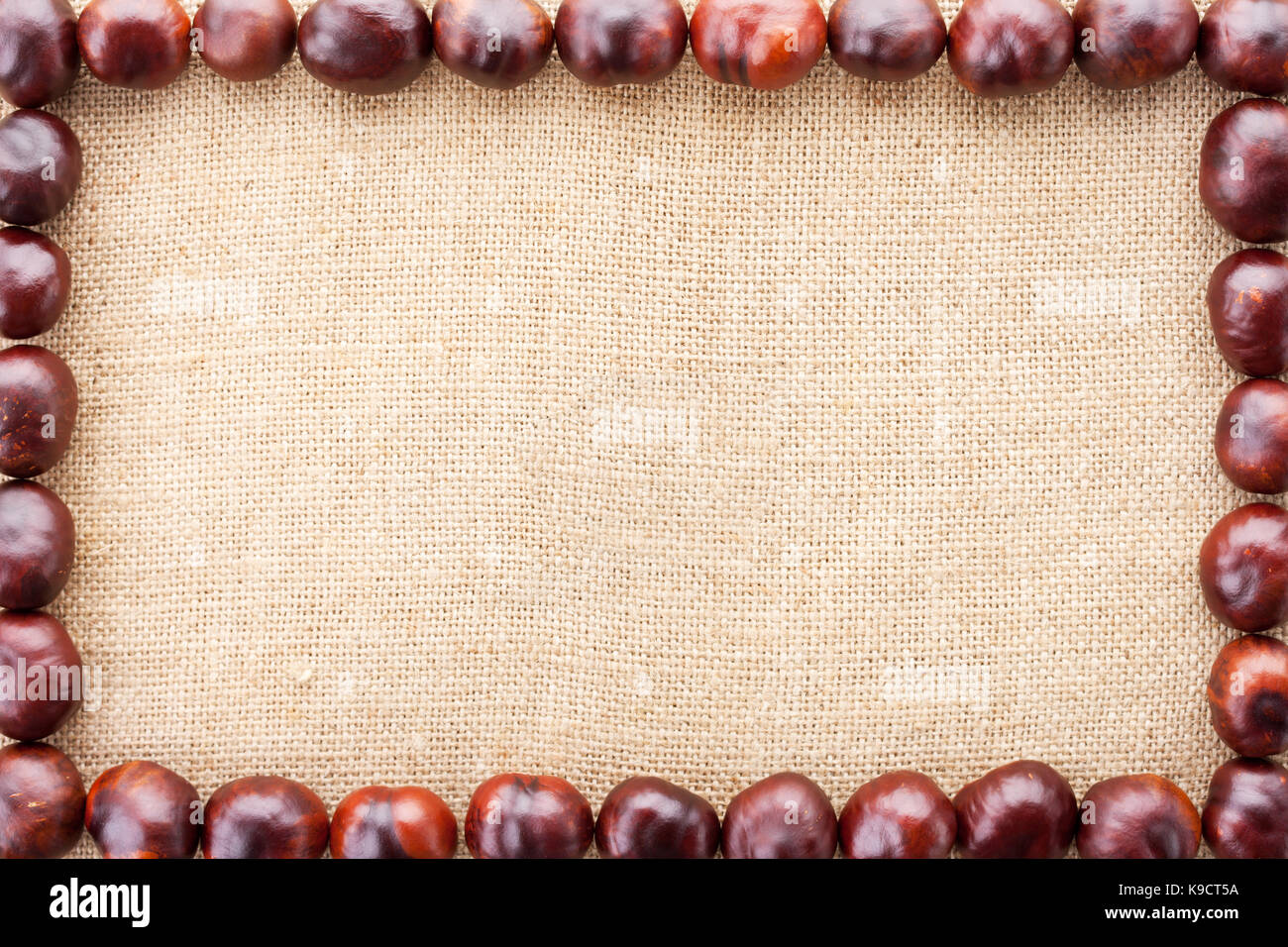 chestnuts frame on fabric texture background Stock Photo - Alamy