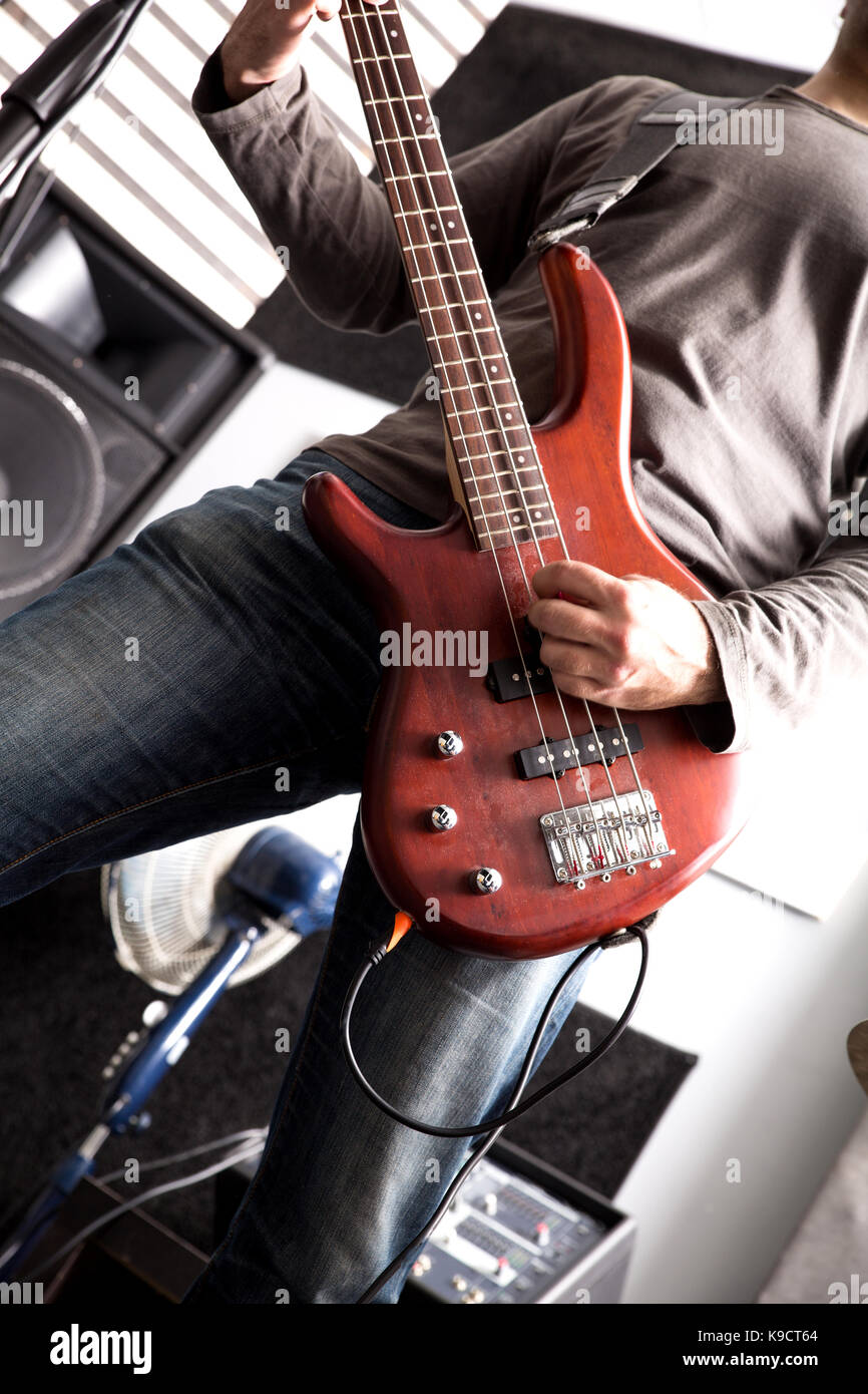 A Rock singer playing bass in the rehearsal Studio Stock Photo - Alamy