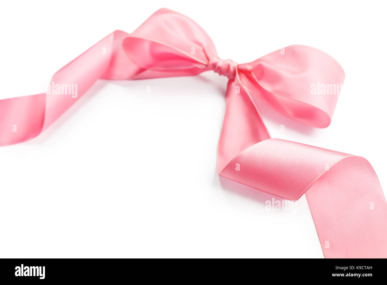 shiny pink satin holiday ribbon and bow isolated on white background ...