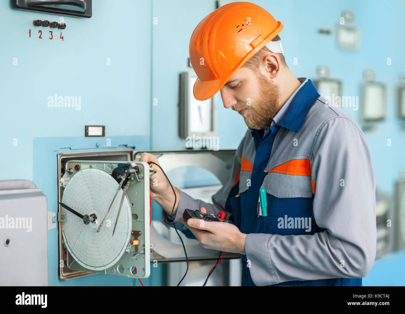 Portrait of young engineer working at control room in factory Stock ...