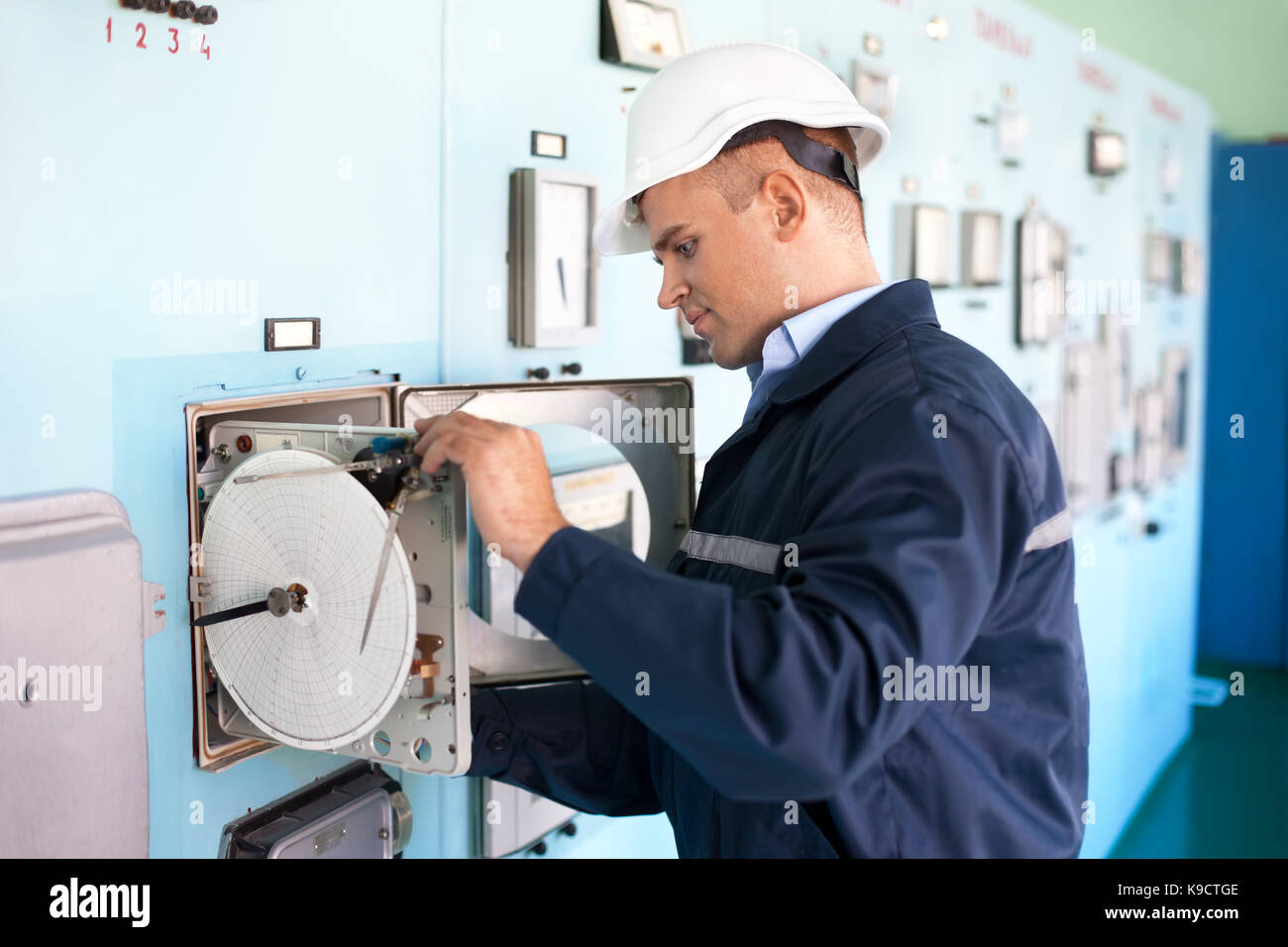 Young engineer working at control room Stock Photo - Alamy