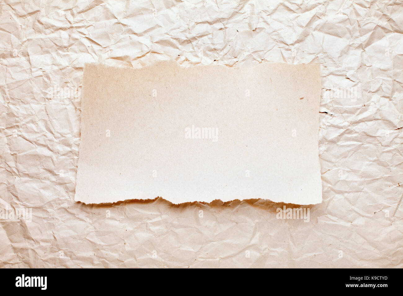 ripped piece of paper on old crushed paper background. vintage retro ...