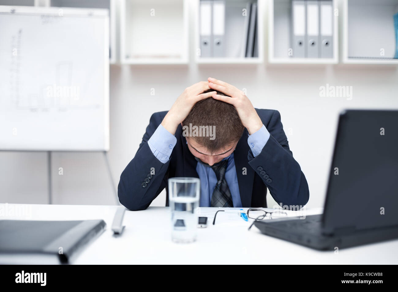 Young business man with problems and stress in the office Stock Photo ...