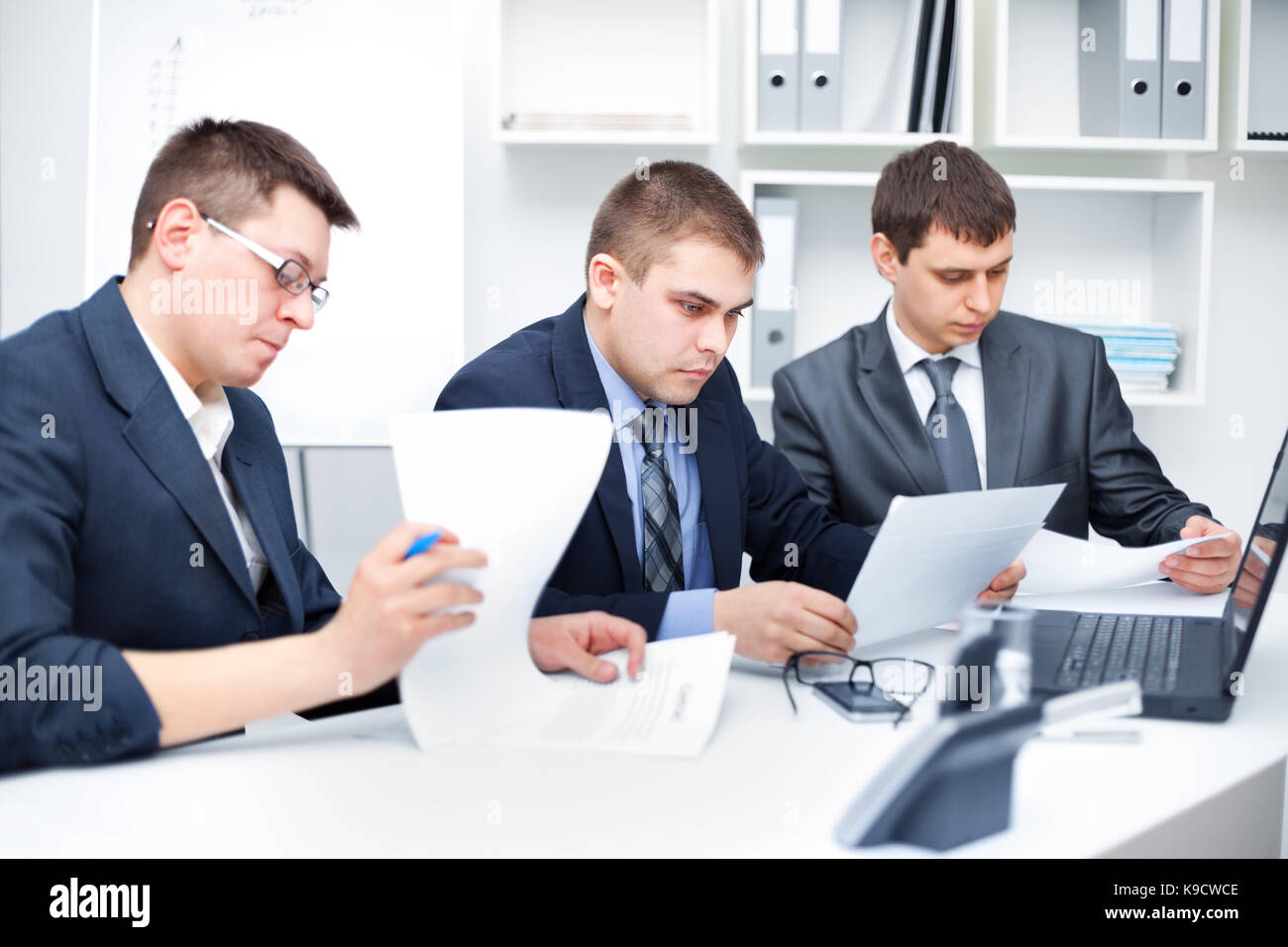Team of young business men working together at office Stock Photo - Alamy