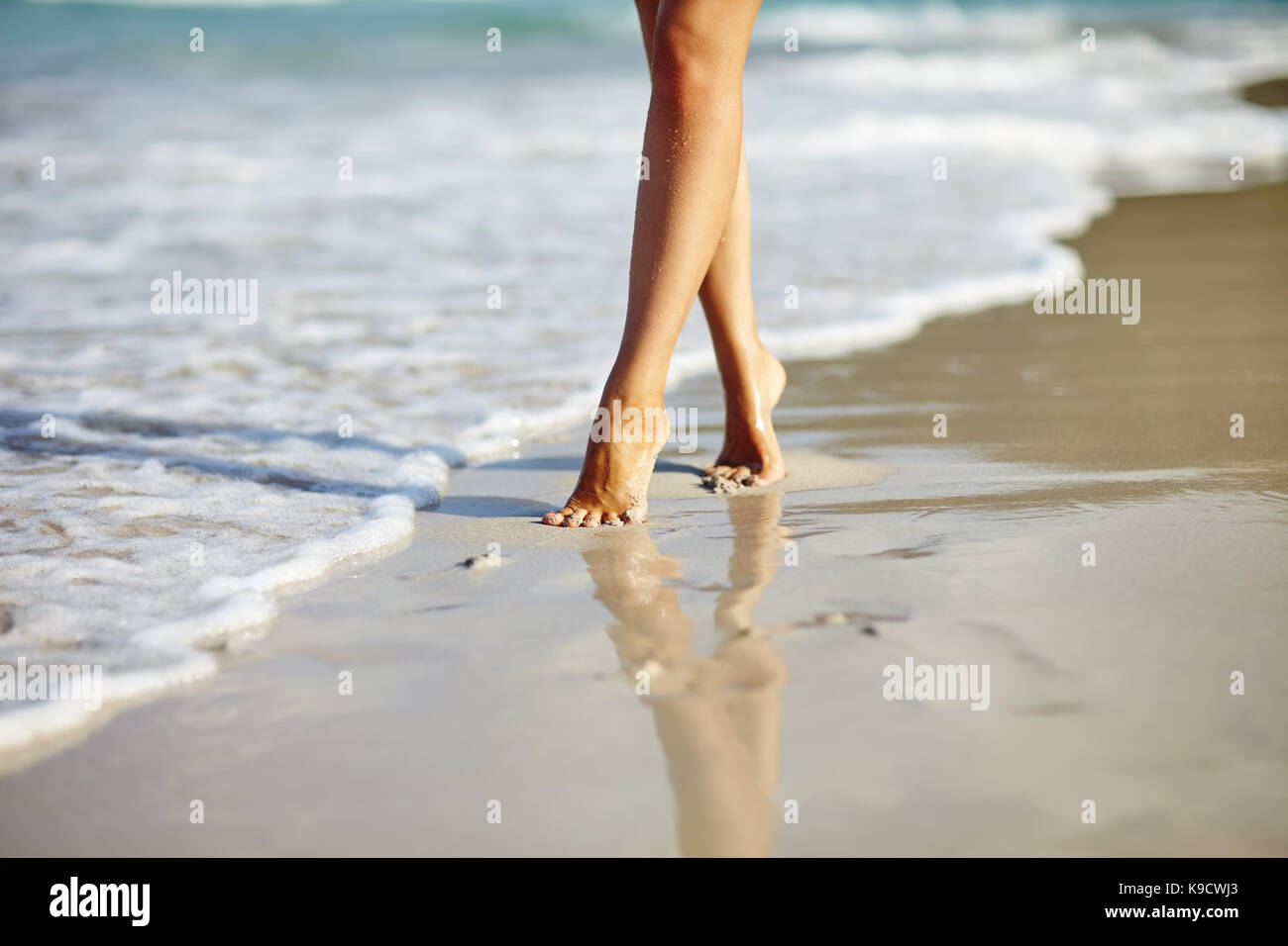 Legs Walking On The Beach