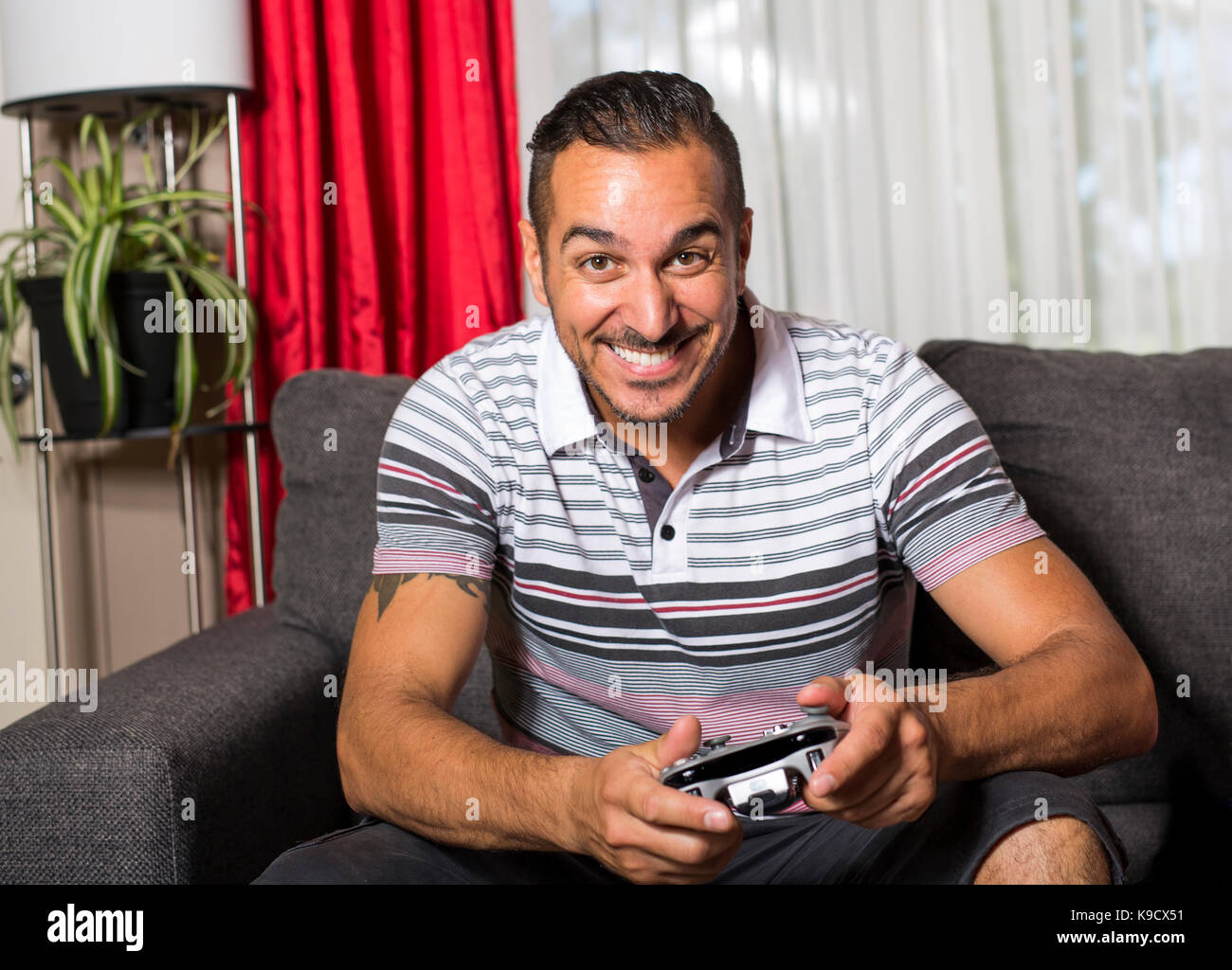 A man playing video game at home Stock Photo - Alamy