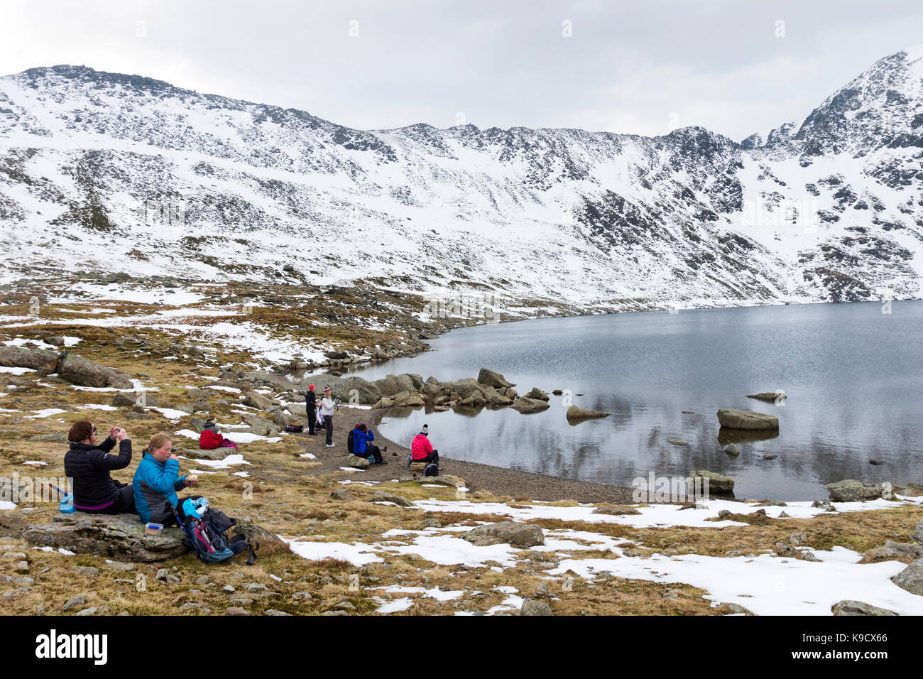 Hikers Taking a Break at Red Tarn Below Striding Edge, Helvellyn, Lake ...