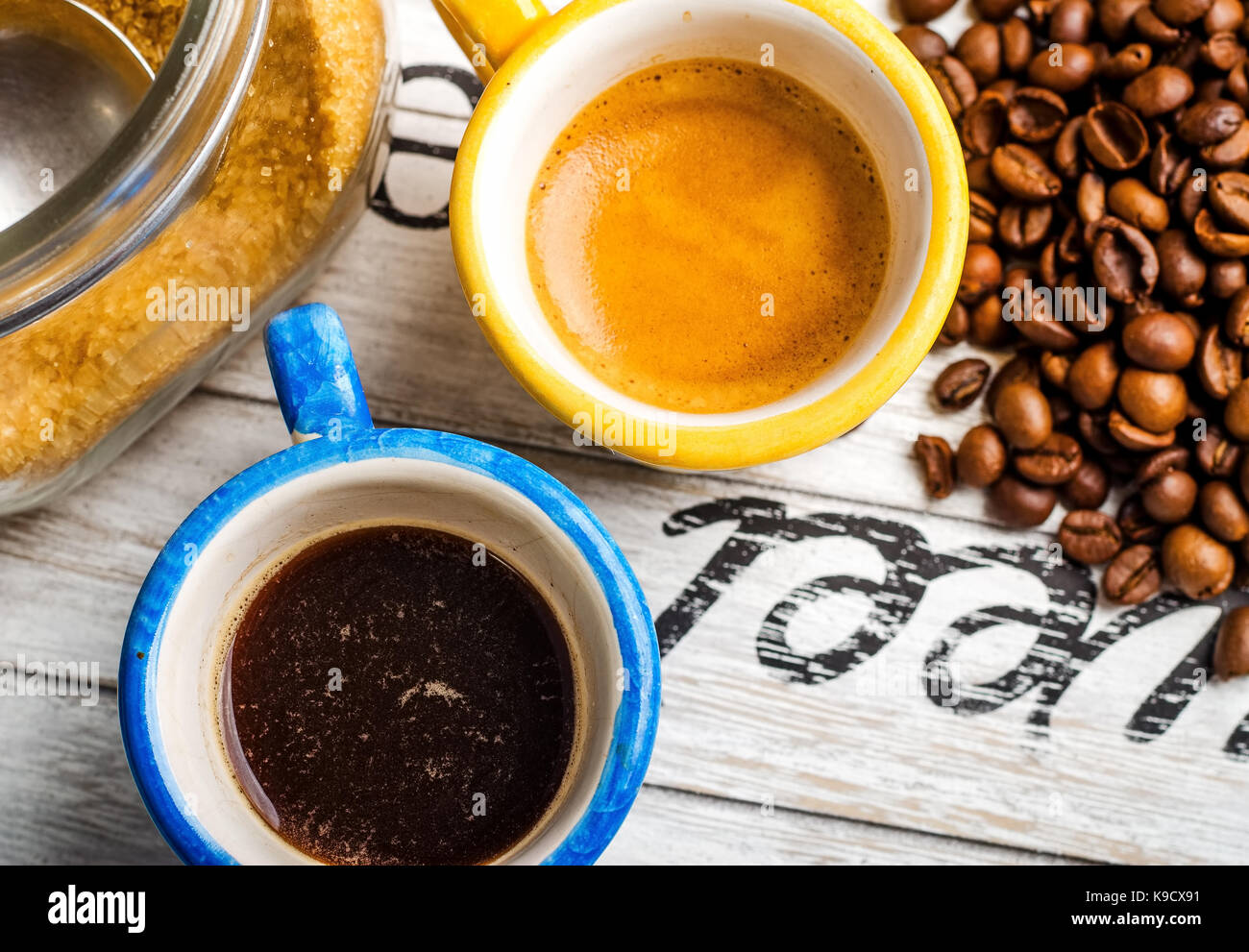 two different cup of coffee and coffee beans and cane sugar Stock Photo ...