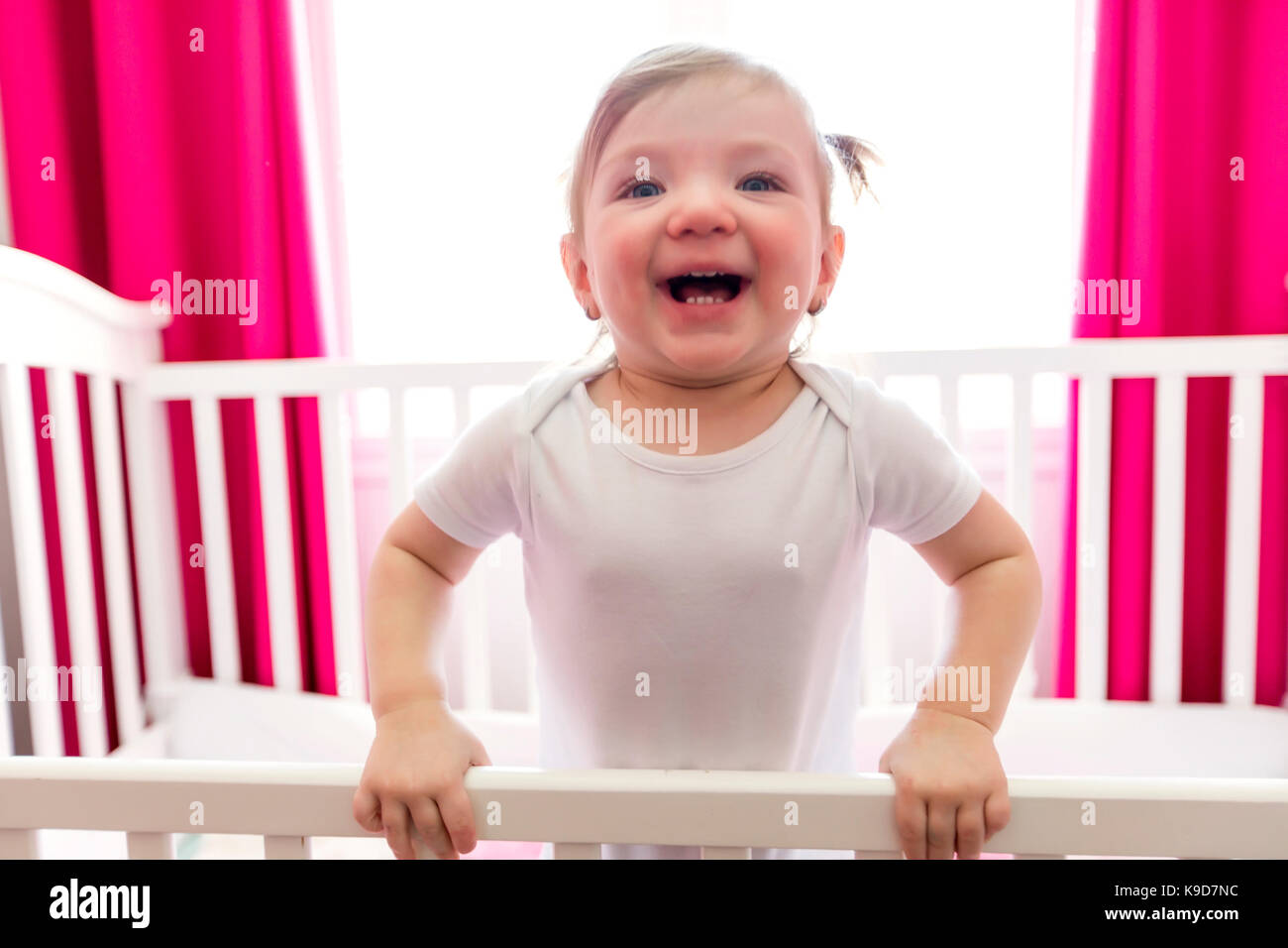 A Cute little girl in cradle at baby room Stock Photo - Alamy