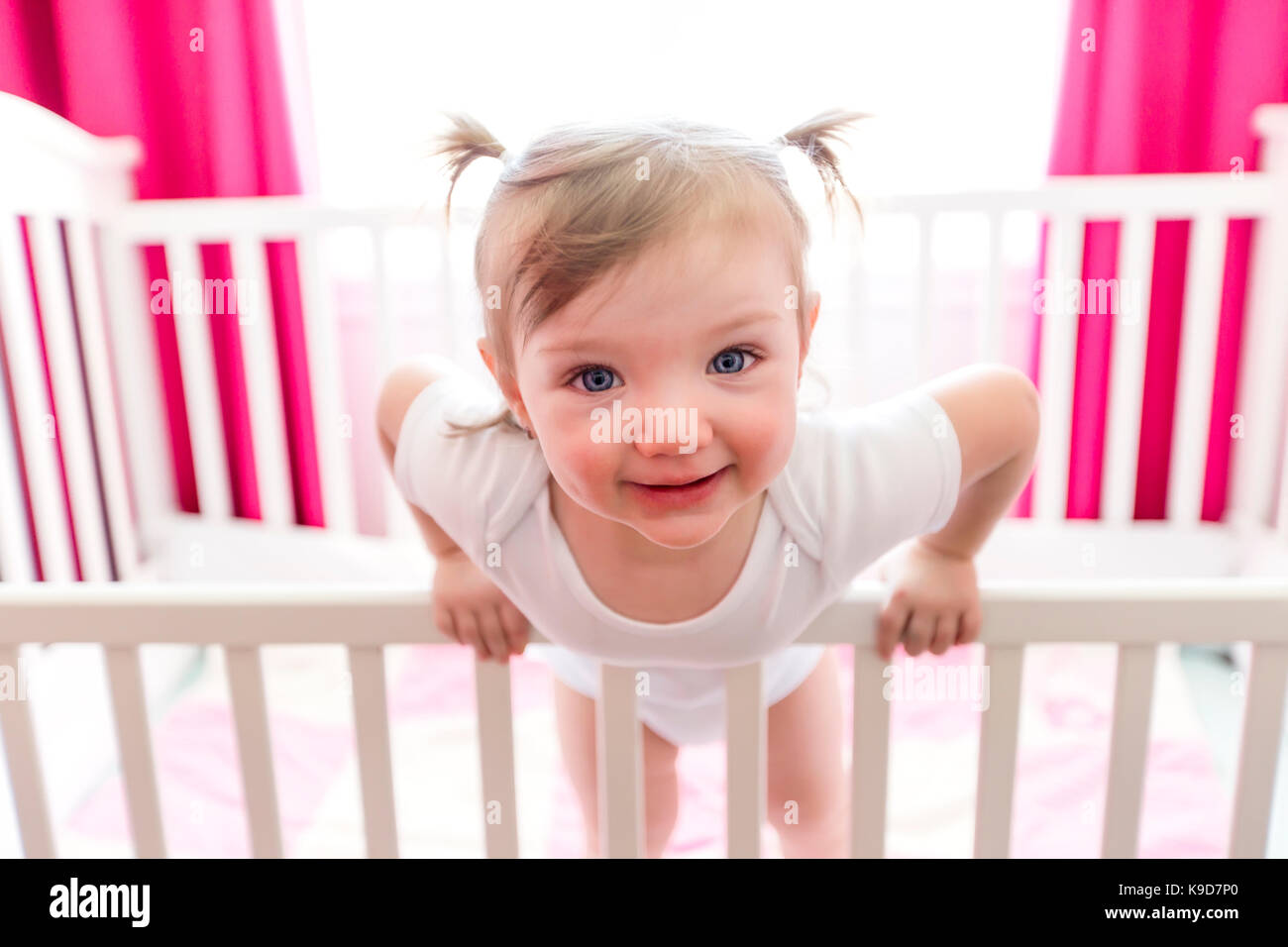 A Cute little girl in cradle at baby room Stock Photo - Alamy