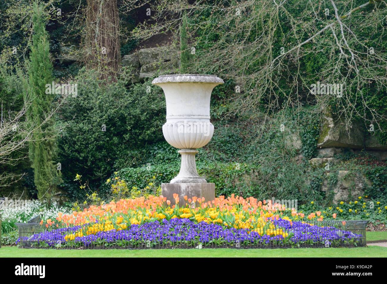 Large outdoor pot in classical garden with flowers Stock Photo - Alamy
