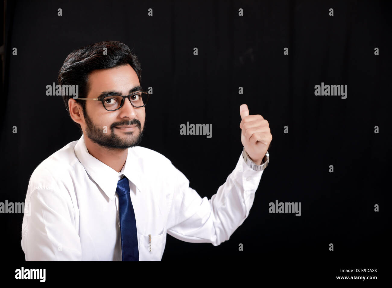 Indian young man showing direction with hand Stock Photo - Alamy