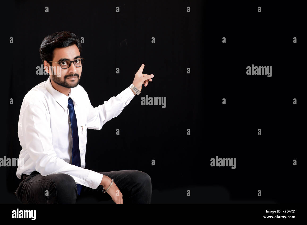 Indian young man showing direction with hand Stock Photo - Alamy