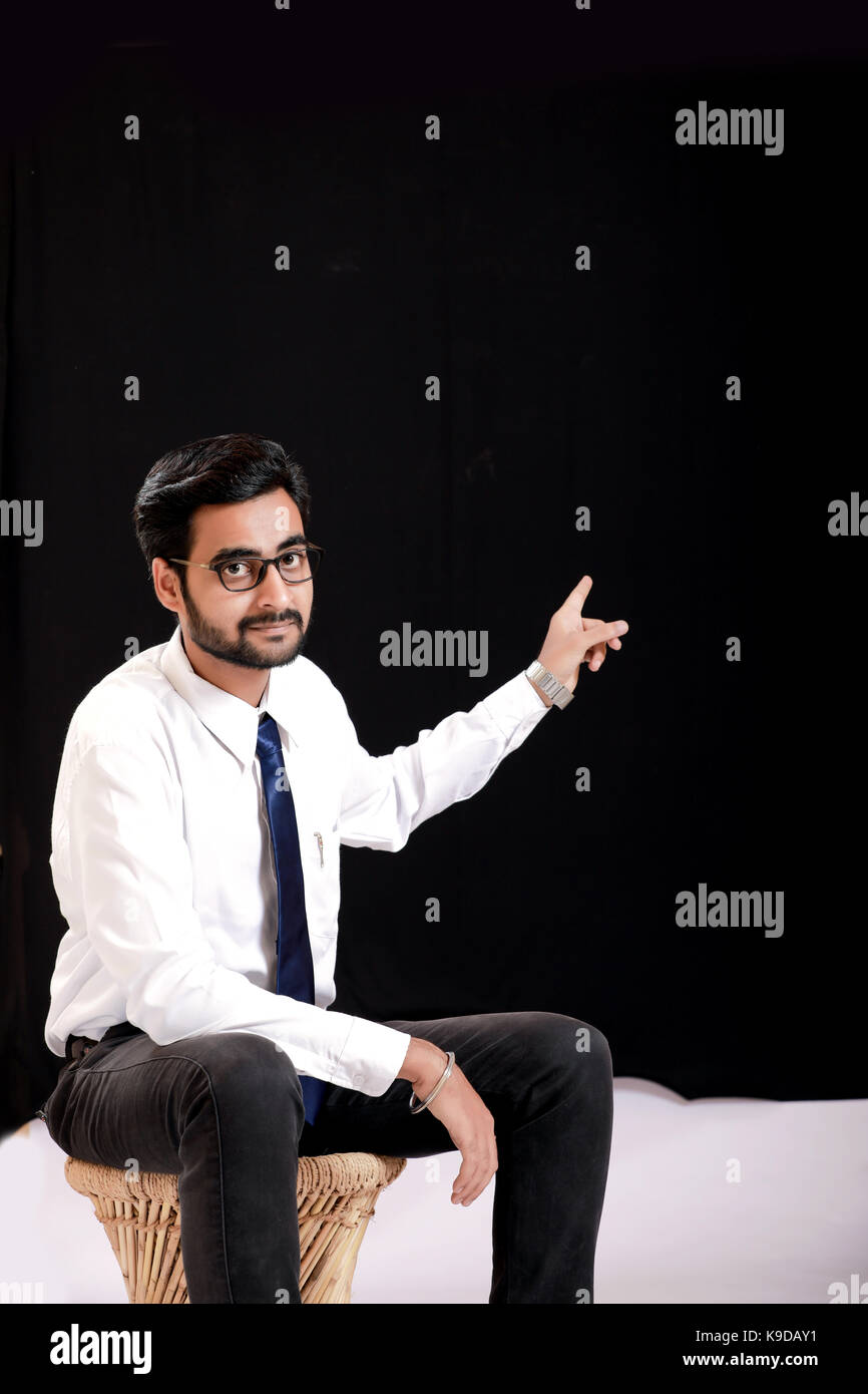Indian young man showing direction with hand Stock Photo - Alamy