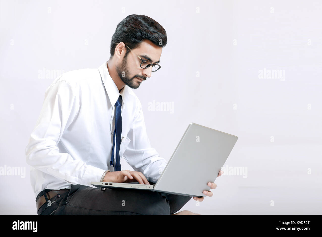 Indian young man with laptop Stock Photo - Alamy