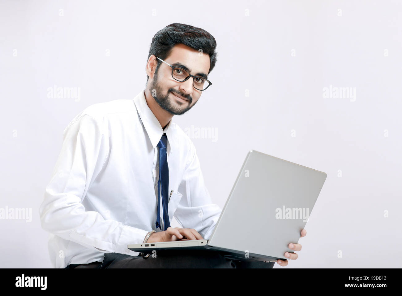 Indian young man with laptop Stock Photo - Alamy